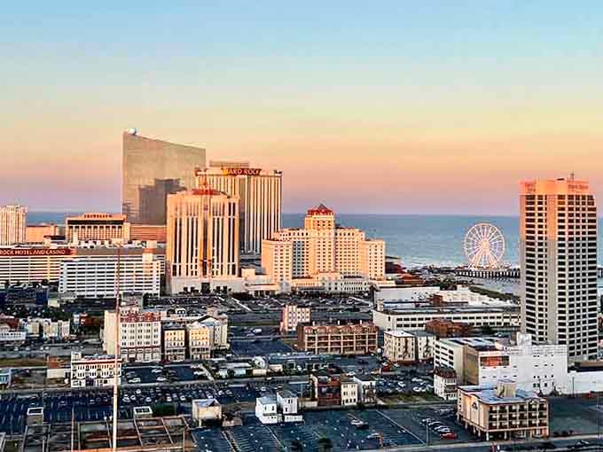 Atlantic City glows at sunset, casinos shimmering, ocean breeze nearby, and the boardwalk spirit ready for another lively night.