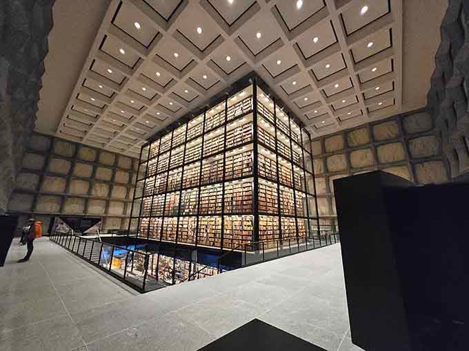 Inside, rare books rise in a glowing tower that looks like something from a science fiction movie set.