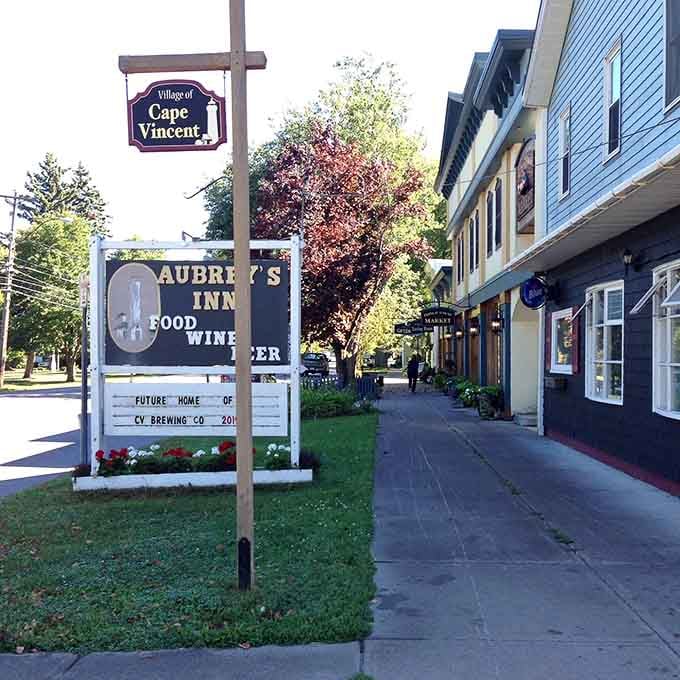 The village sign and welcoming storefronts invite you to slow down, park the car, and explore on foot.
