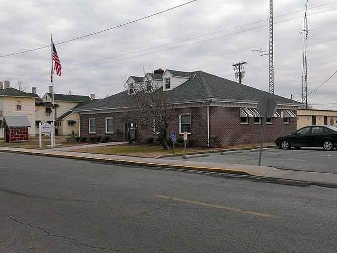 The American flag waves proudly over brick buildings that have witnessed generations of small-town life.