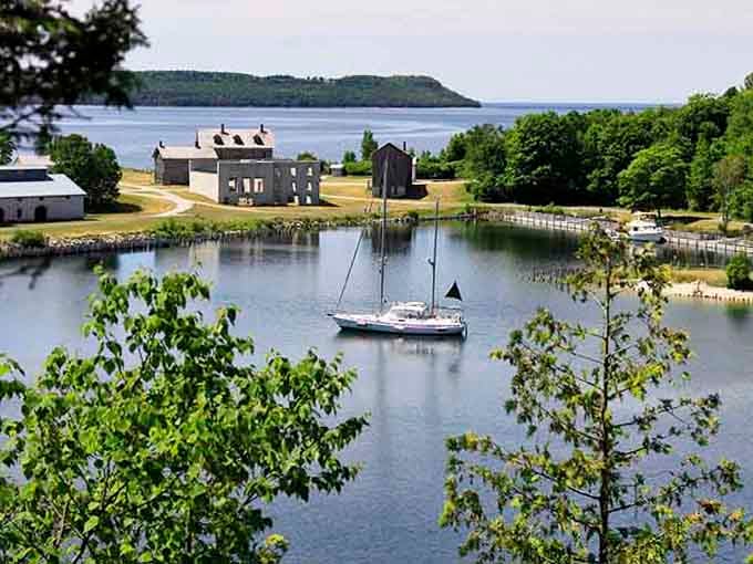 The peaceful harbor reflects historic structures where workers once labored in Michigan's industrial boom era of yesterday.