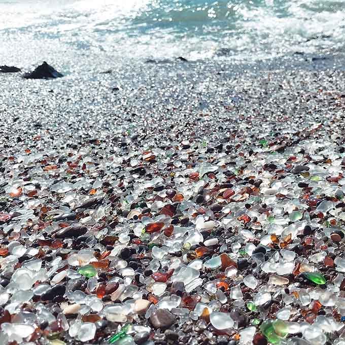 Thousands of jewel-toned glass pieces catch the sunlight, proving that time and tide can turn mistakes into magic.