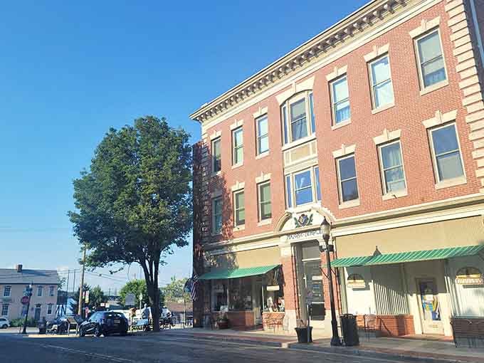 Classic storefronts line the quiet street where awnings provide shade and architectural details tell stories of bygone eras.