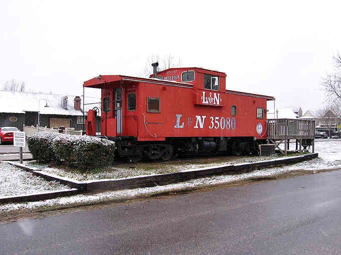 That bright red caboose sits like a cheerful reminder of when trains connected every small town in America.
