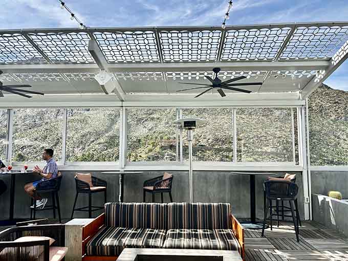 Modern pergola design filters sunshine into artistic patterns across this mountain-view drinking spot with style.