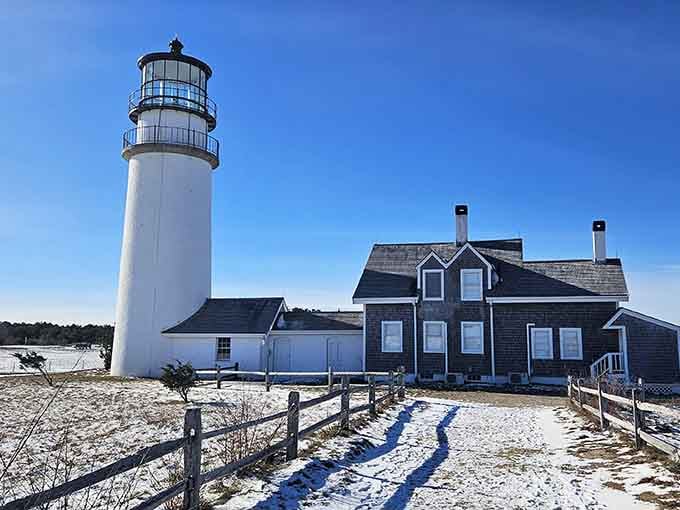 Winter's blanket transforms the keeper's house into a snow globe scene, peaceful and pristine beside the frozen shore.