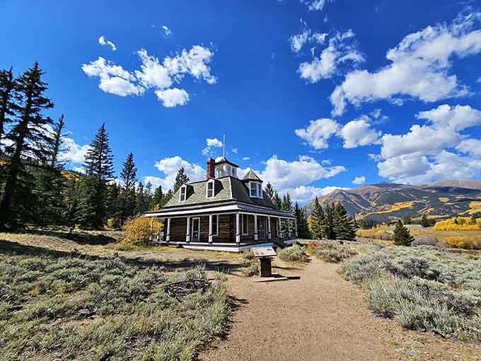 The old hotel waits beneath endless skies, surrounded by golden aspens and memories of laughter long faded.