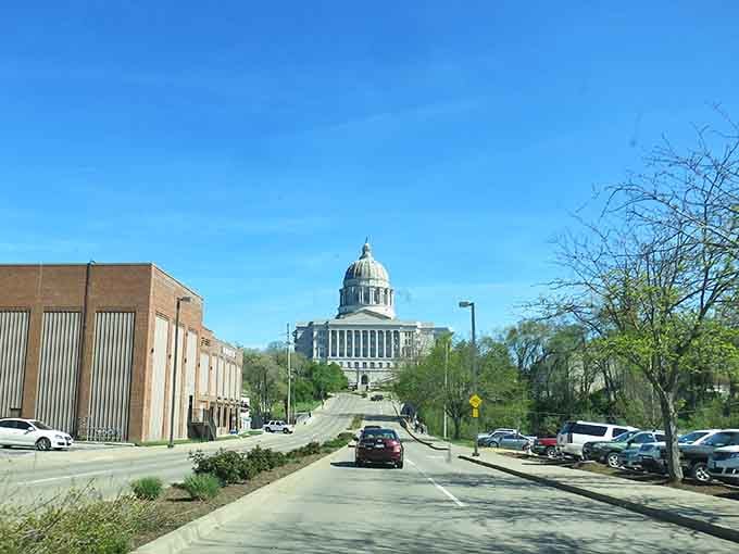 The state capitol dome rises majestically at street's end, commanding attention like Missouri's own Washington Monument moment.