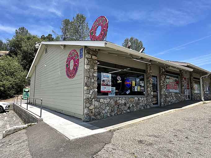 That cheerful pink donut sign perched on the roof guides hungry travelers to generous portions and friendly service.