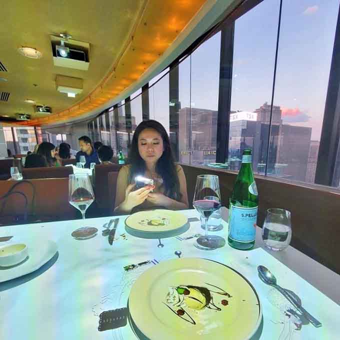 The artistic plating and skyline views combine for a dining experience that's equal parts dinner theater and culinary magic show.