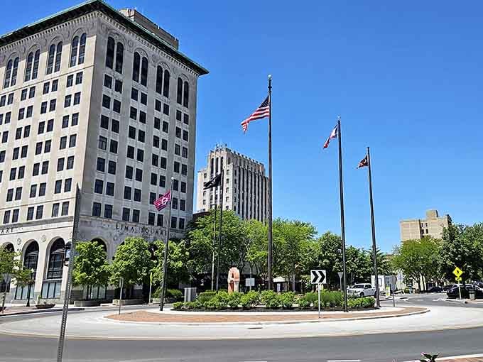 Flags wave above manicured greenery in the town square, where civic pride shows in every well-maintained detail you see.
