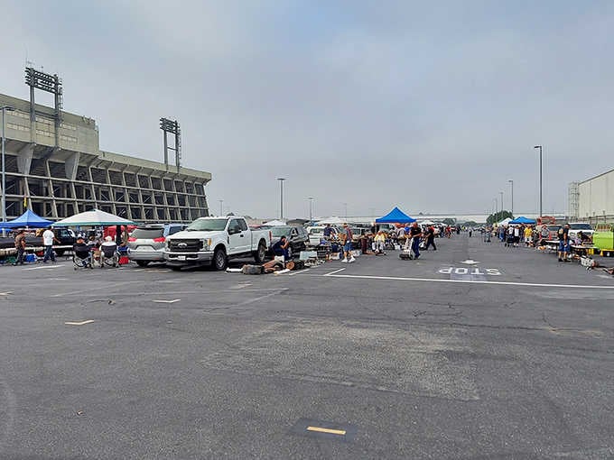 The stadium backdrop adds drama to this treasure hunt where vintage textiles and handmade goods await eager buyers.