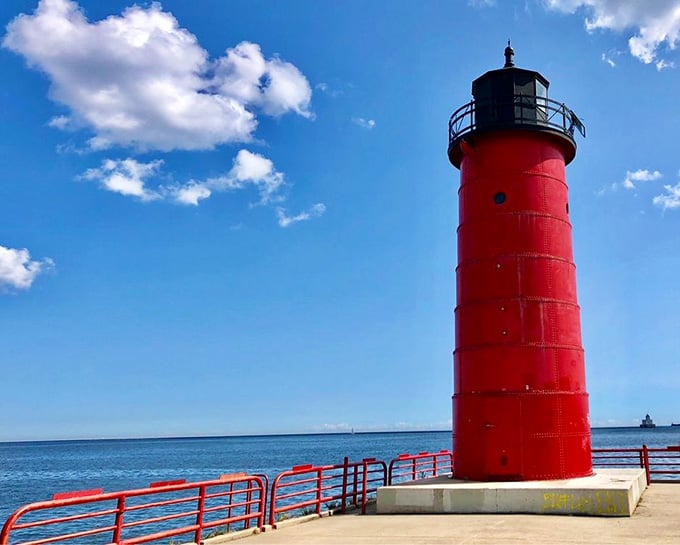The graffiti-covered base tells tales of modern visitors while the lighthouse top maintains its dignified watch over Lake Michigan's waves.