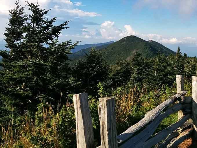 Weathered fence posts frame the summit view like a rustic picture frame showcasing millions of acres of untouched wilderness.