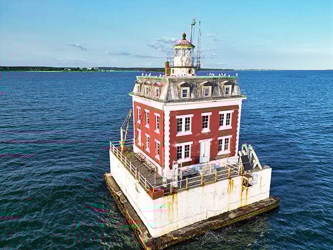 Bright sunshine illuminates every architectural detail of this remarkable structure standing watch over the harbor entrance below.