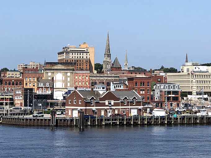 The historic waterfront skyline rises from the Thames River, showing layers of architectural history stacked like a wedding cake of eras.