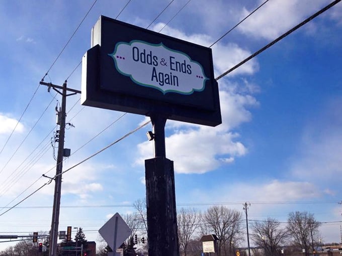 The roadside sign stands tall against blue skies, guiding savvy shoppers to their next unexpected discovery.