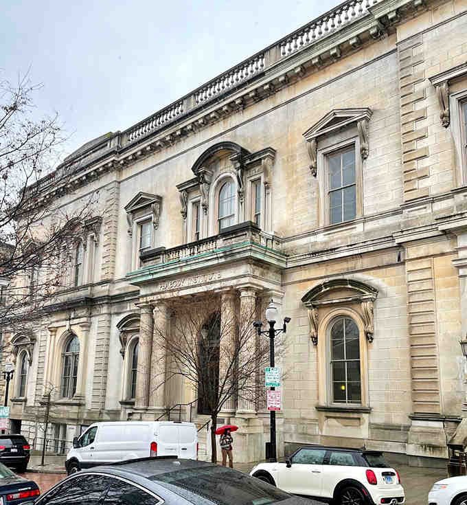 The classical facade whispers of bygone elegance when libraries were temples and reading was considered a noble pursuit.