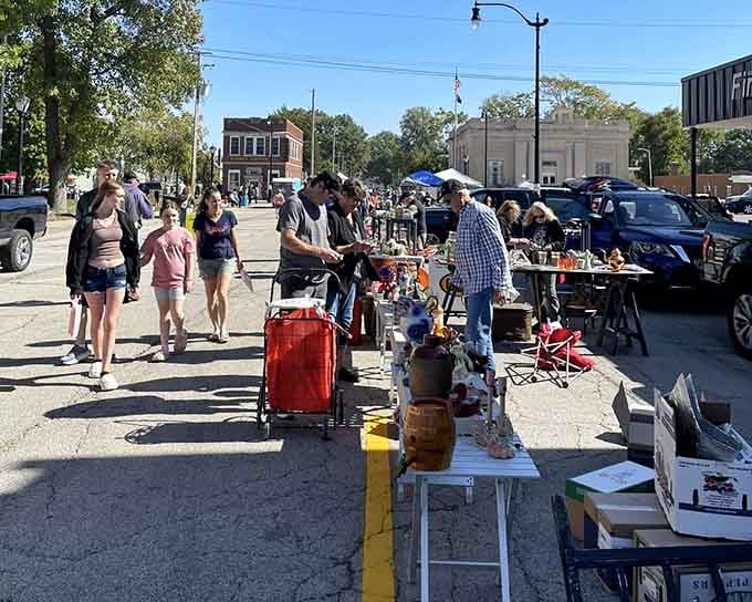 Small-town charm radiates from these street vendors where morning sunshine illuminates tables filled with unexpected treasures and memories.