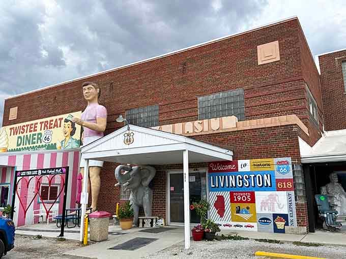 The elephant statue stands proudly beneath dramatic clouds, marking this Route 66 landmark where memories and collectibles find new homes.