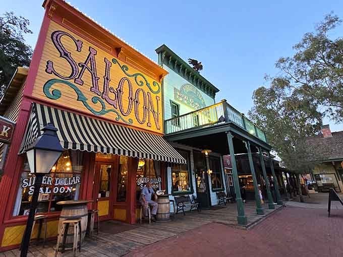Pink benches line the dusty street where steakhouse dreams meet authentic frontier atmosphere and wide-open spaces.