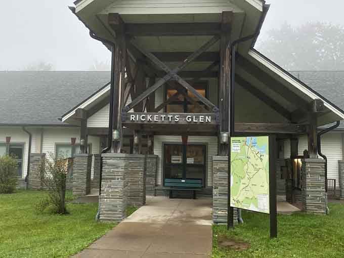 The rustic entrance beckons hikers into a wilderness where 22 waterfalls await along trails that wind through ancient Pennsylvania woodlands.