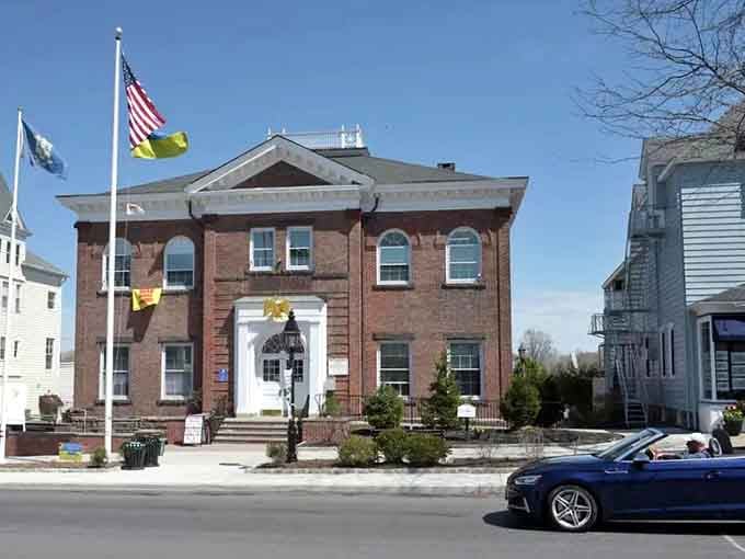 Flags flutter outside this solid brick building where community decisions have been made for longer than you've been alive.
