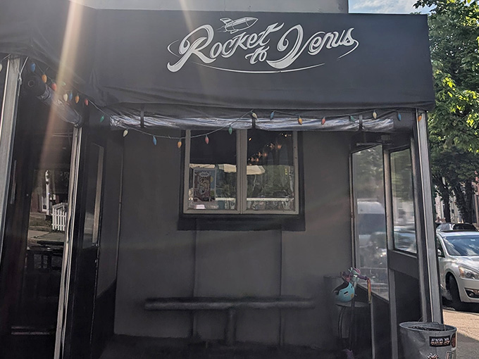 The sleek black awning and vintage script lettering transport you to a 1950s vision of tomorrow's coolest bar.