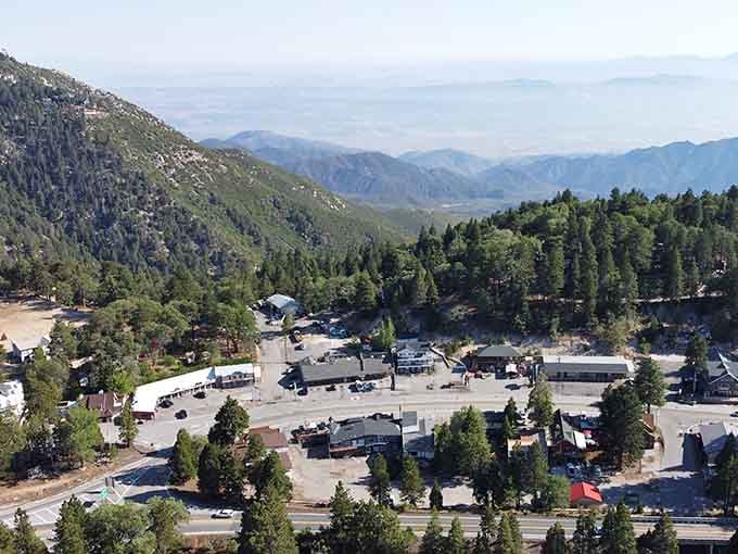 This elevated view shows how mountain communities nestle into valleys surrounded by endless forests stretching toward distant horizons.