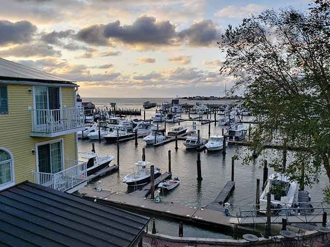 Marina slips filled with bobbing boats catch the golden sunset, painting the perfect picture of coastal Connecticut living at its finest.