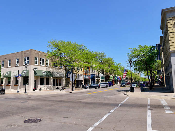 Spring greenery frames a main street where local shops still outnumber chain stores by a comfortable margin.