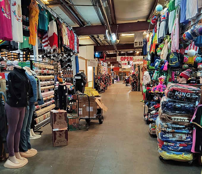 Colorful clothing racks stretch endlessly down this aisle where yesterday's fashion becomes tomorrow's perfect find waiting just for you.