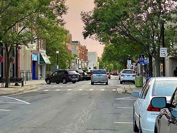 Tree-lined downtown where parallel parking is an art form and everybody knows to slow down to fifteen.