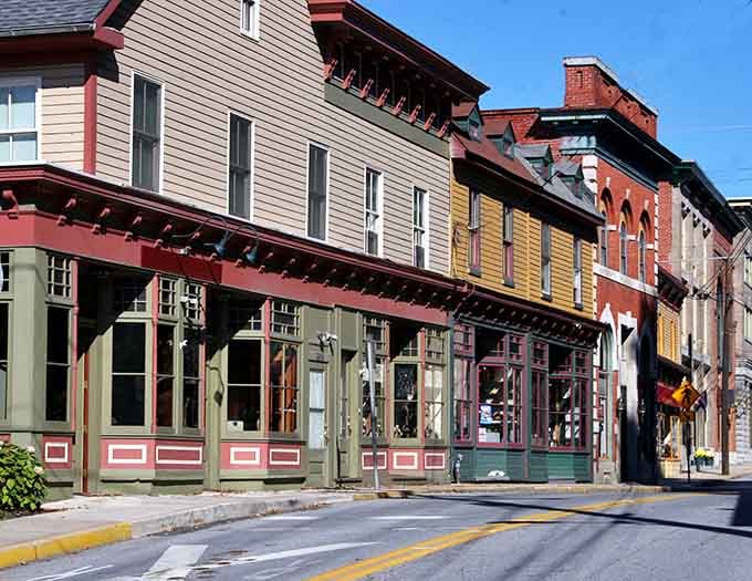 Historic buildings wearing their age like badges of honor along streets that remember when horses outnumbered cars.