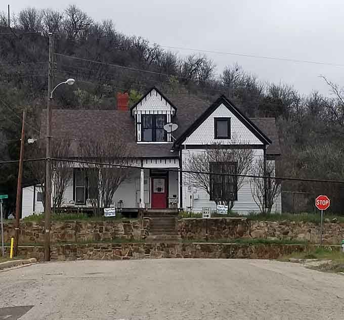 That distinctive tower rises against gray skies, making this hilltop house look like it's auditioning for horror films.
