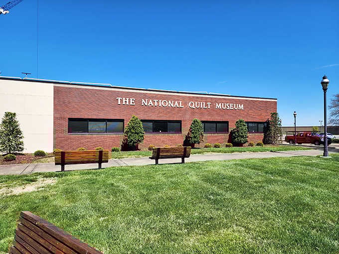 Manicured landscaping and inviting benches frame this cultural treasure where fabric becomes fine art.