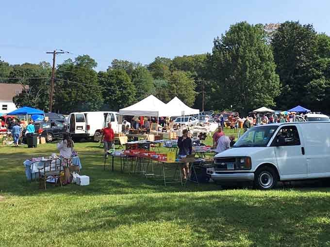 Vendors cluster under summer sun, their colorful tents creating a patchwork quilt of shopping possibilities ahead.