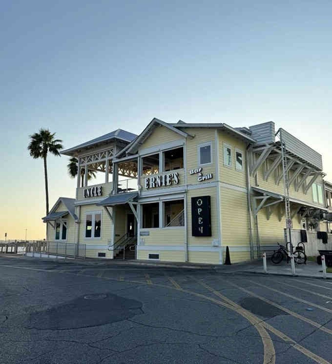 That pale yellow building at sunset looks like it's been kissed by golden hour, making everything more magical.