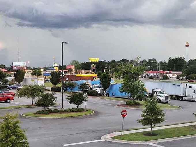 Storm clouds gather over this commercial strip, but the rainbow promise hints at the affordable sunshine waiting here.
