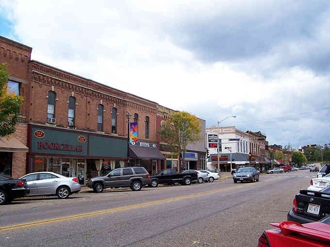 Red brick facades glow under moody skies, creating Main Street magic that doesn't cost a Hollywood budget.