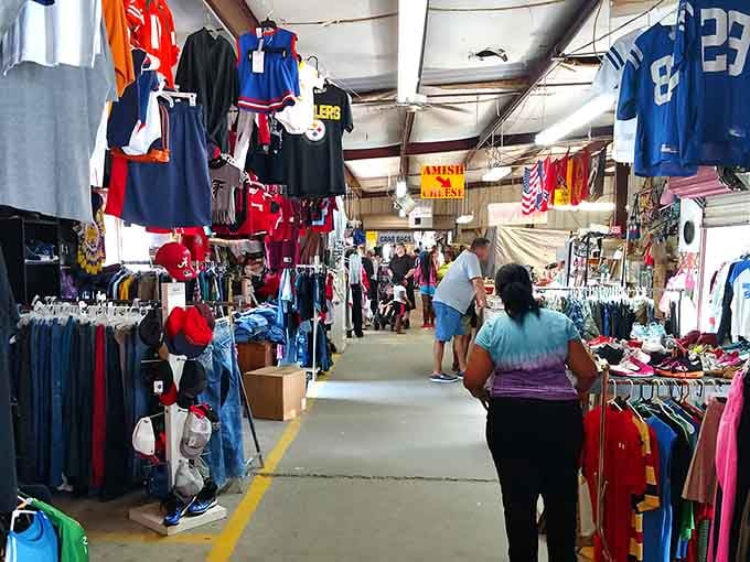Sports jerseys hang like colorful flags overhead while shoppers navigate aisles packed with everything imaginable below.
