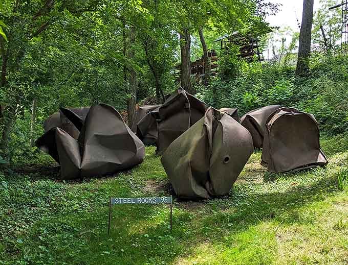 Massive crumpled steel forms look like giant paper wads tossed aside, transforming industrial material into surprisingly organic shapes.