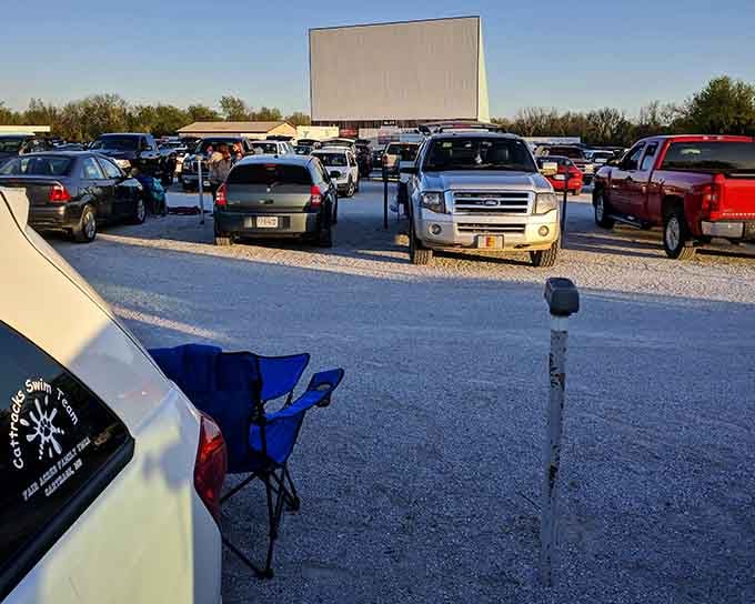 Rows of vehicles create a modern-day wagon circle, all facing the same direction for an evening of shared storytelling.