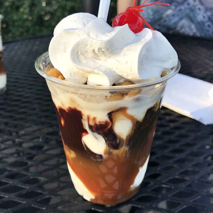 The Tin Roof Sundae brings vintage soda fountain vibes with chocolate, peanuts, and enough whipped cream for days.