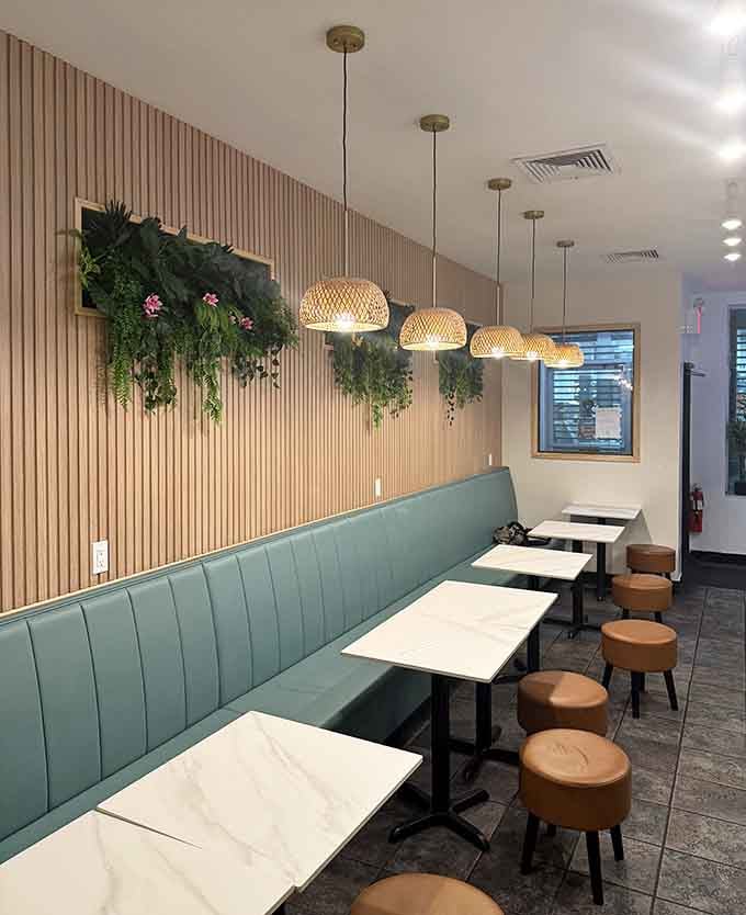 Banquette seating, hanging greenery, and natural wood create a space that's Instagram-ready without trying too hard.