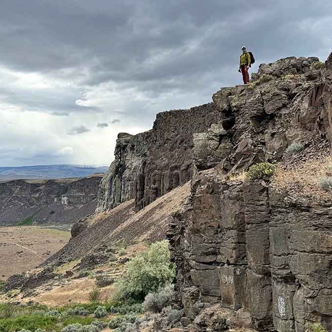 Standing atop columnar basalt formations, contemplating geology and also wondering if your health insurance covers extreme photo opportunities.