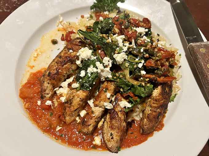 Grilled chicken over marinara with feta and greens &ndash; Mediterranean flavors getting cozy with Southern hospitality works beautifully.