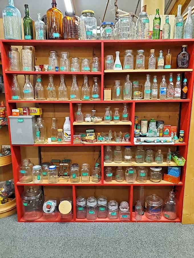 Vintage bottles and jars organized by color, proving that even old containers deserve their moment to shine.