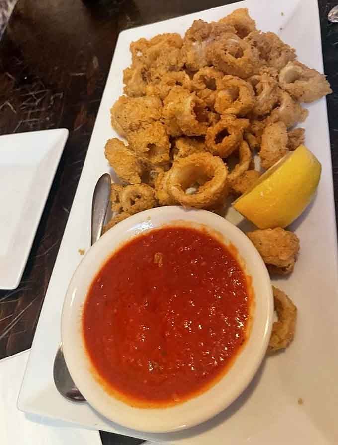 Golden fried calamari with marinara sauce proves that some classics never need improvement, just proper execution.