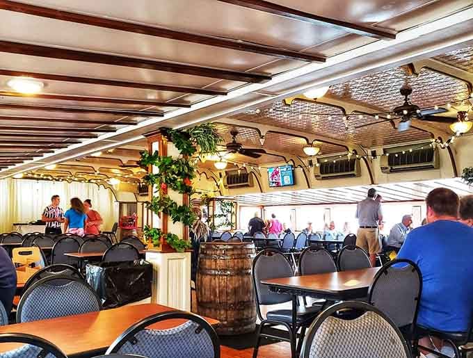 The dining area combines vintage charm with ceiling fans, because even steamboat passengers deserve comfort while they cruise and dine.